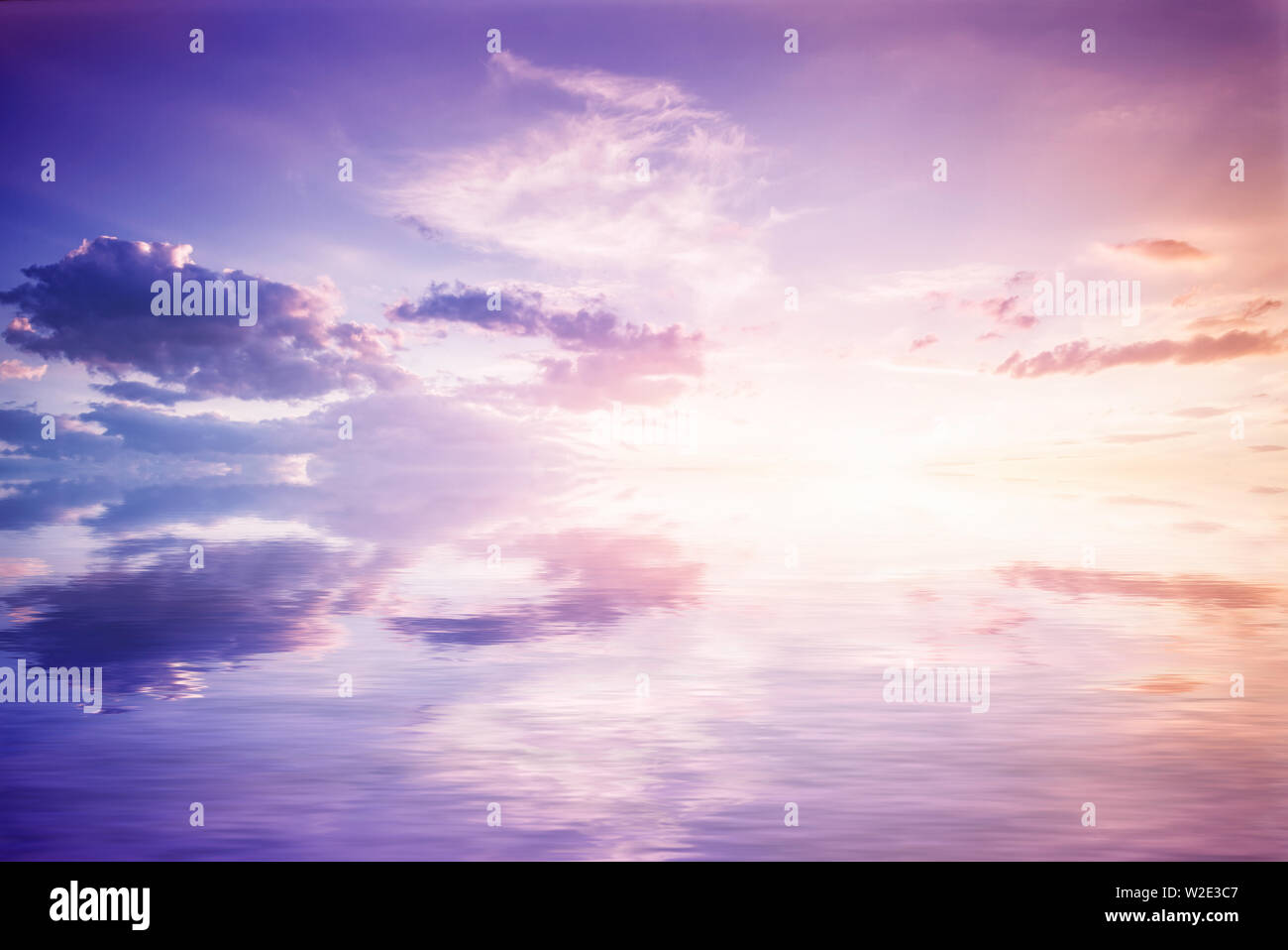 Abstract reflection in water. Reflected purple sky with clouds and ...