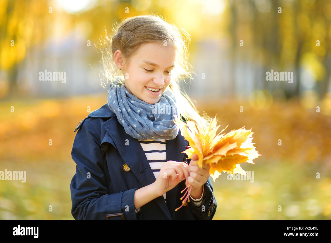 Adorable young girl having fun on beautiful autumn day. Happy child ...