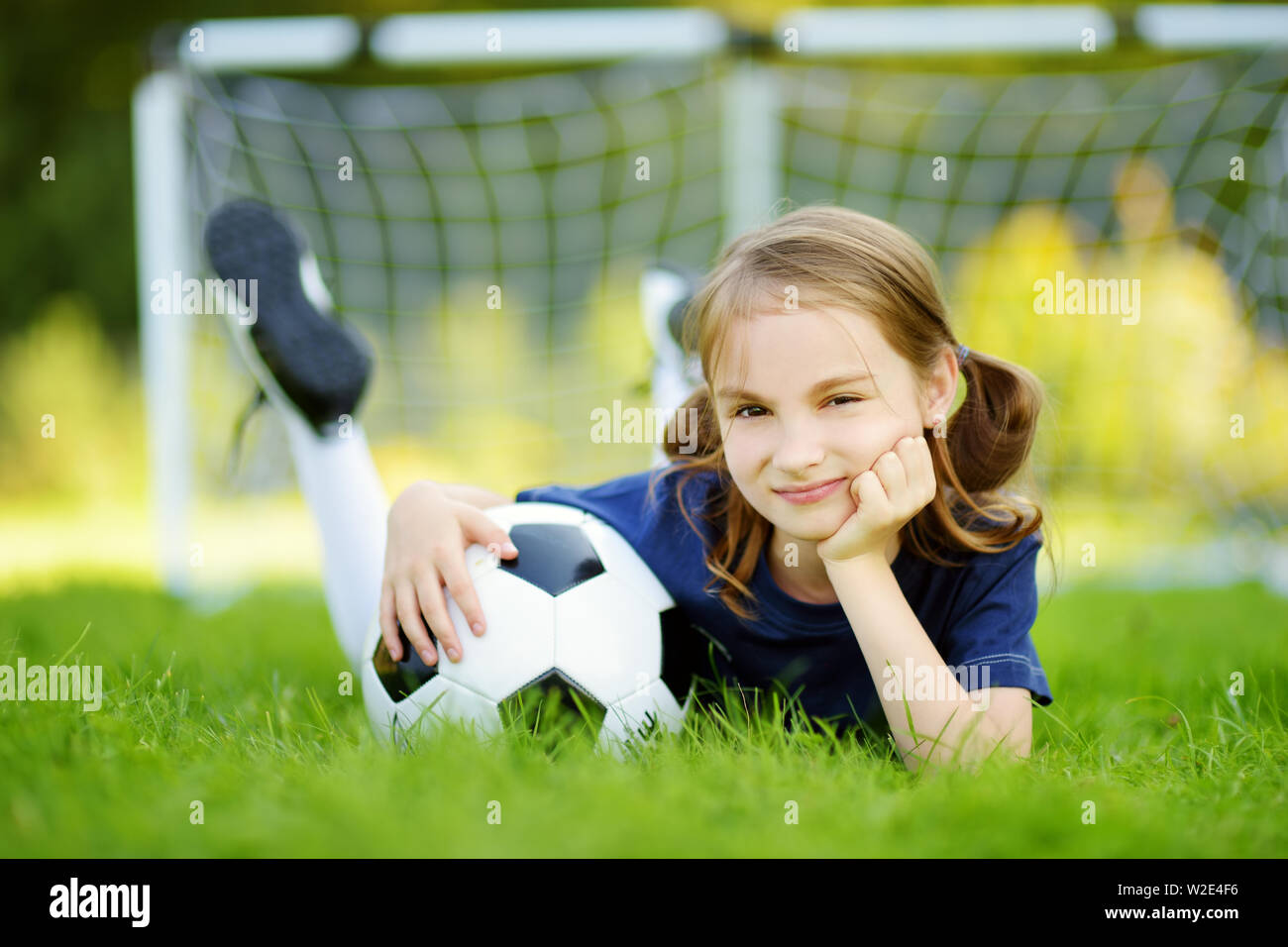Cute little soccer player having fun playing a soccer game on sunny ...