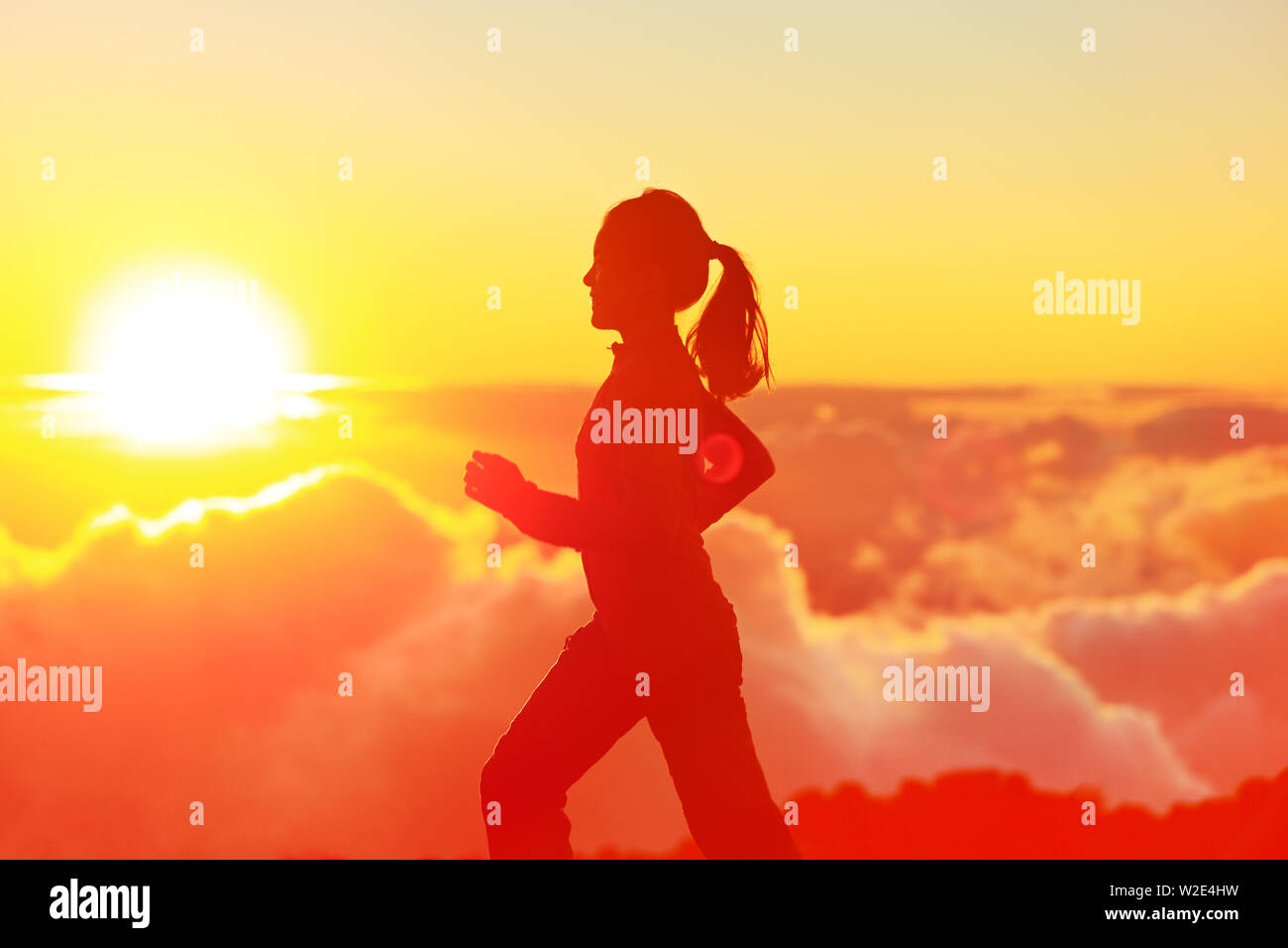 Runner woman running in sunshine sunset. Fitness athlete training trail ...