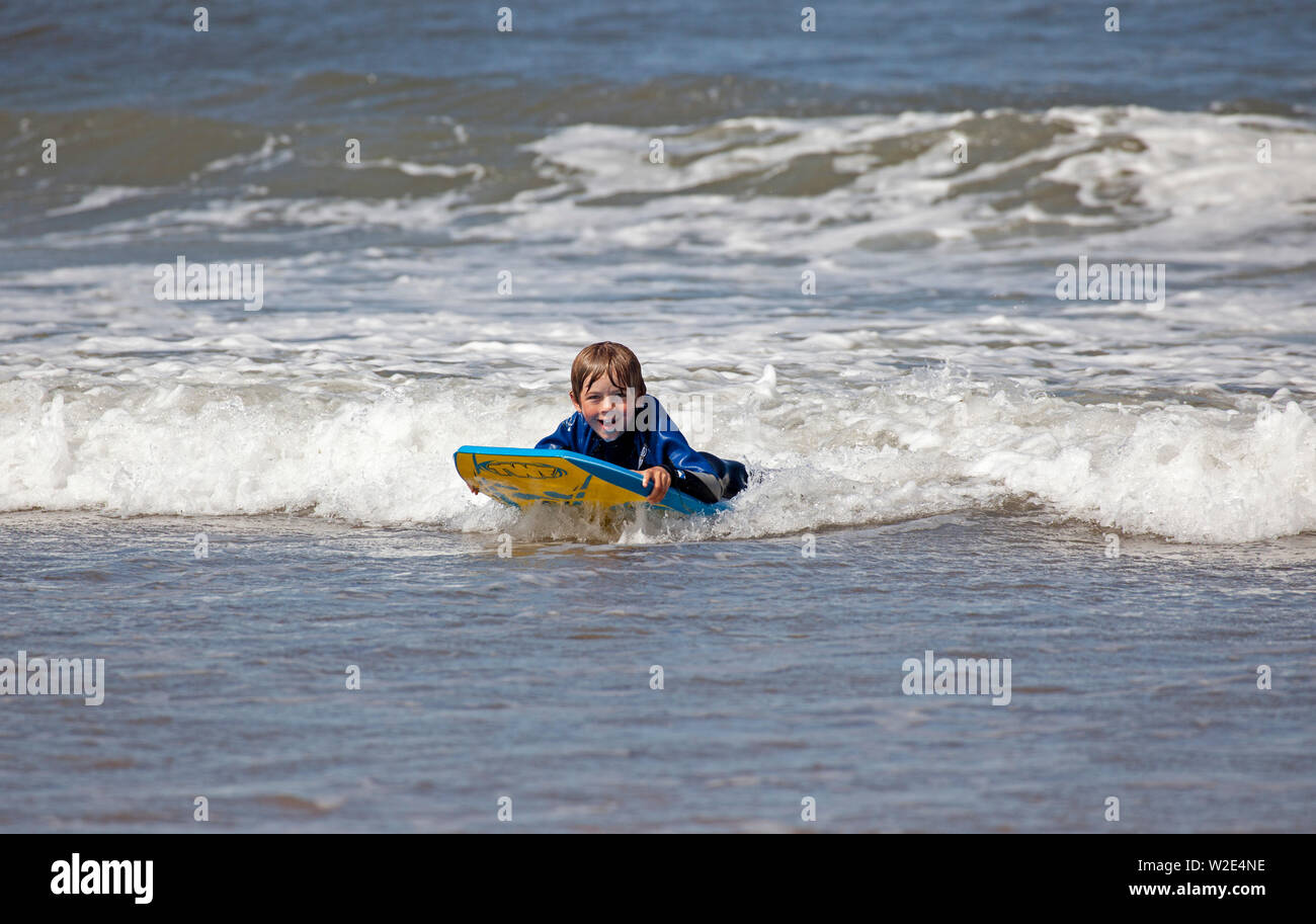Young boy with bodyboard hi-res stock photography and images - Alamy