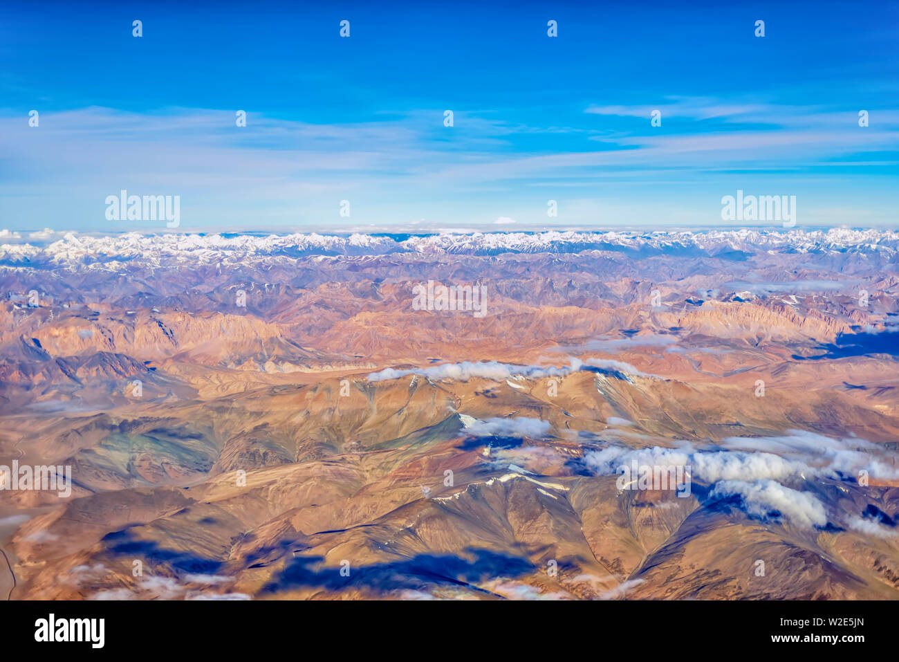 Spotty clouds over the multi-coloured barren mountains of the Zanskar ...