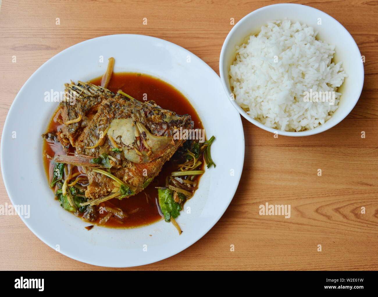 deep fried mango fish head dressing ginger and soy sauce with plain ...