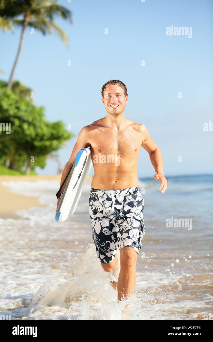 Beach lifestyle people - man surfer with surfing bodyboard running in ...