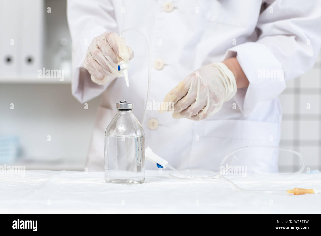 The doctor prepares a dropper with a solution of medicine. Close up ...