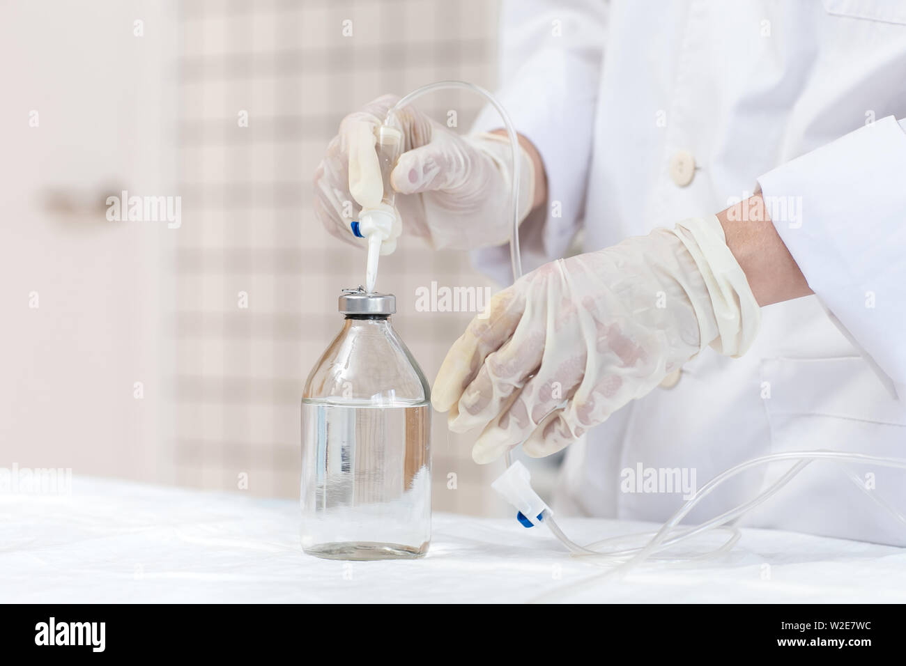 The doctor prepares a dropper with a solution of medicine. Close up ...