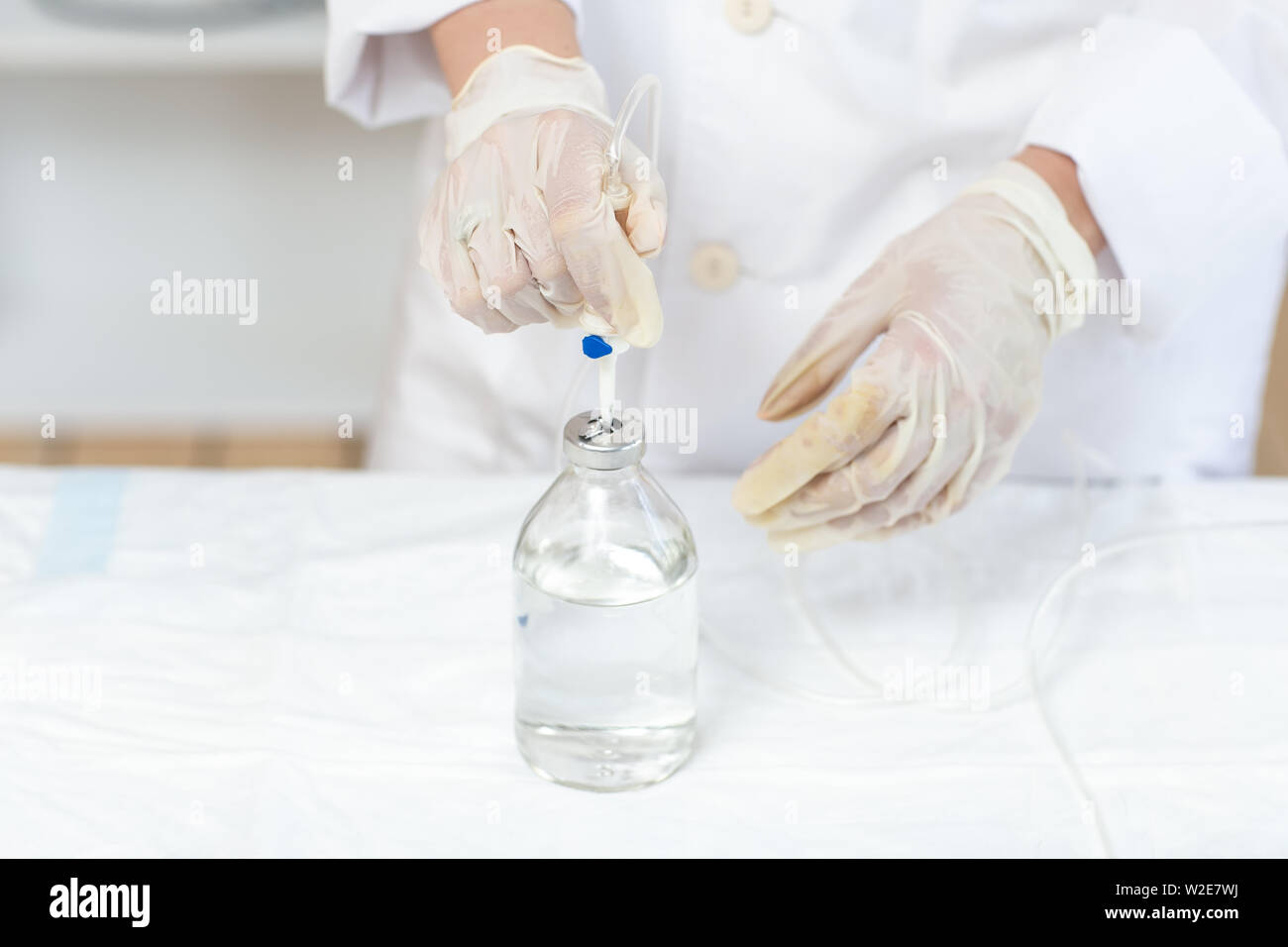 The doctor prepares a dropper with a solution of medicine. Close up ...