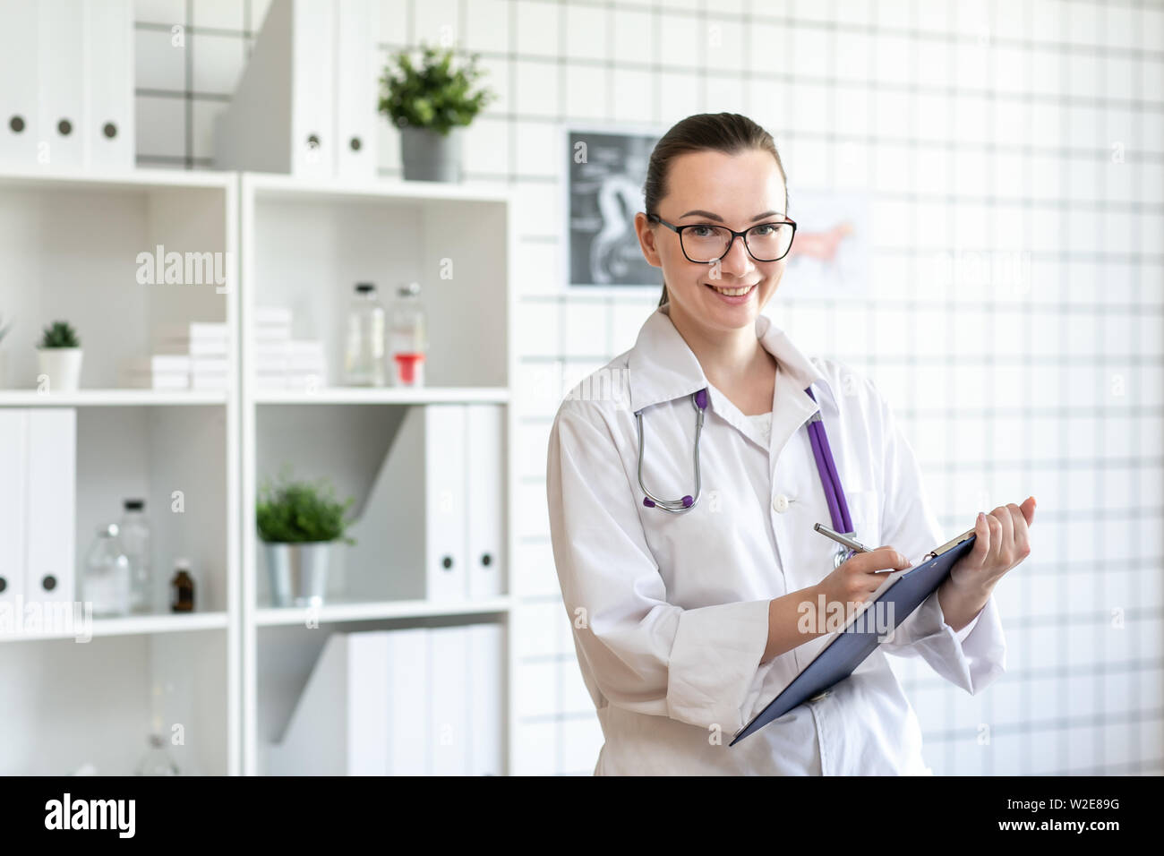 Portrait of a veterinarian doctor with a smile. Blurred background of ...