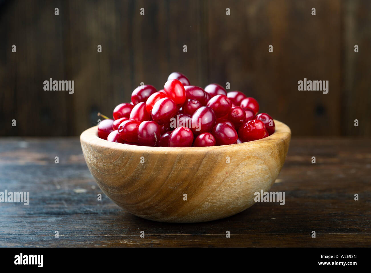 fresh cornel berries in brown bowl. Top view Stock Photo - Alamy