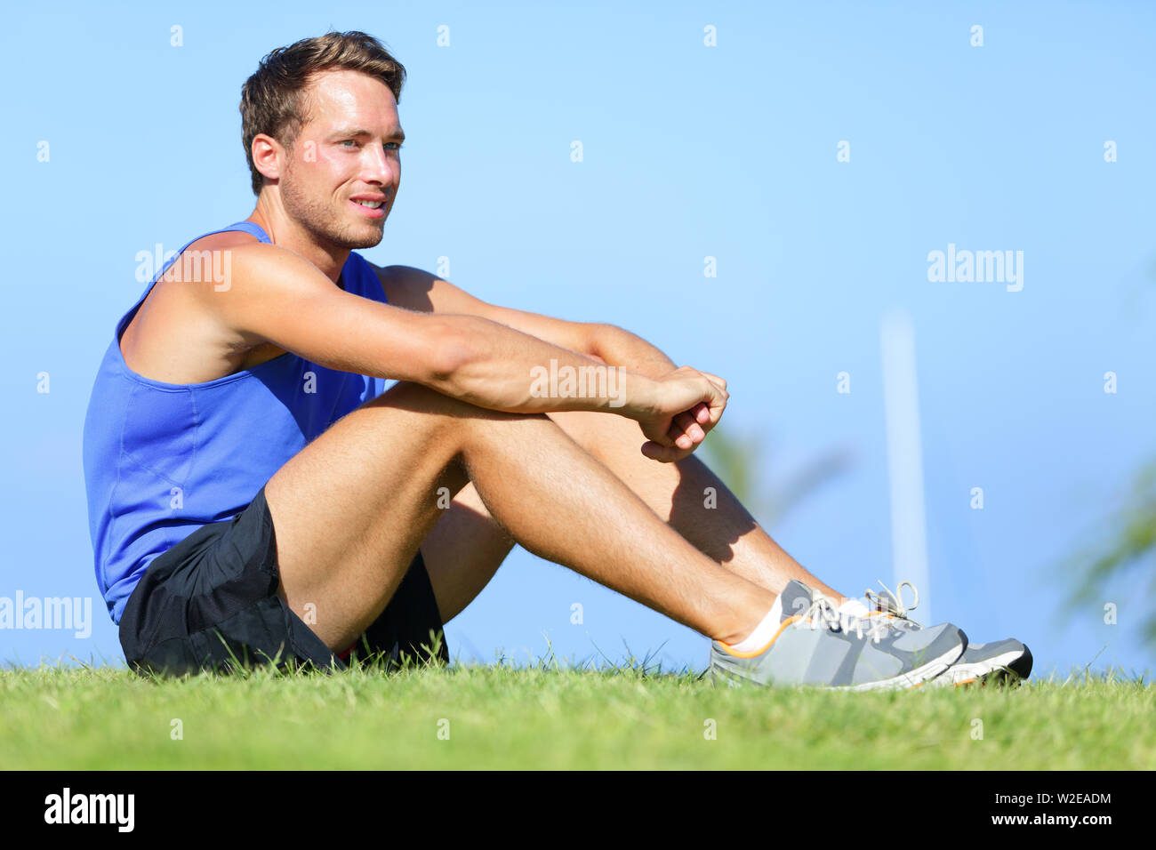 Sport fitness man relaxing after training outdoor. Young male athlete ...