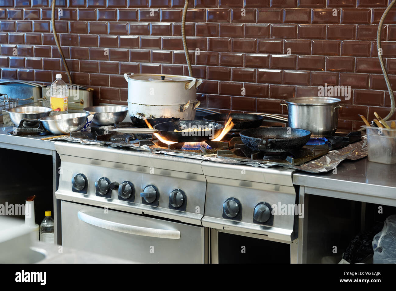 Typical kitchen of a restaurant in operation, pan on gas burner Stock ...