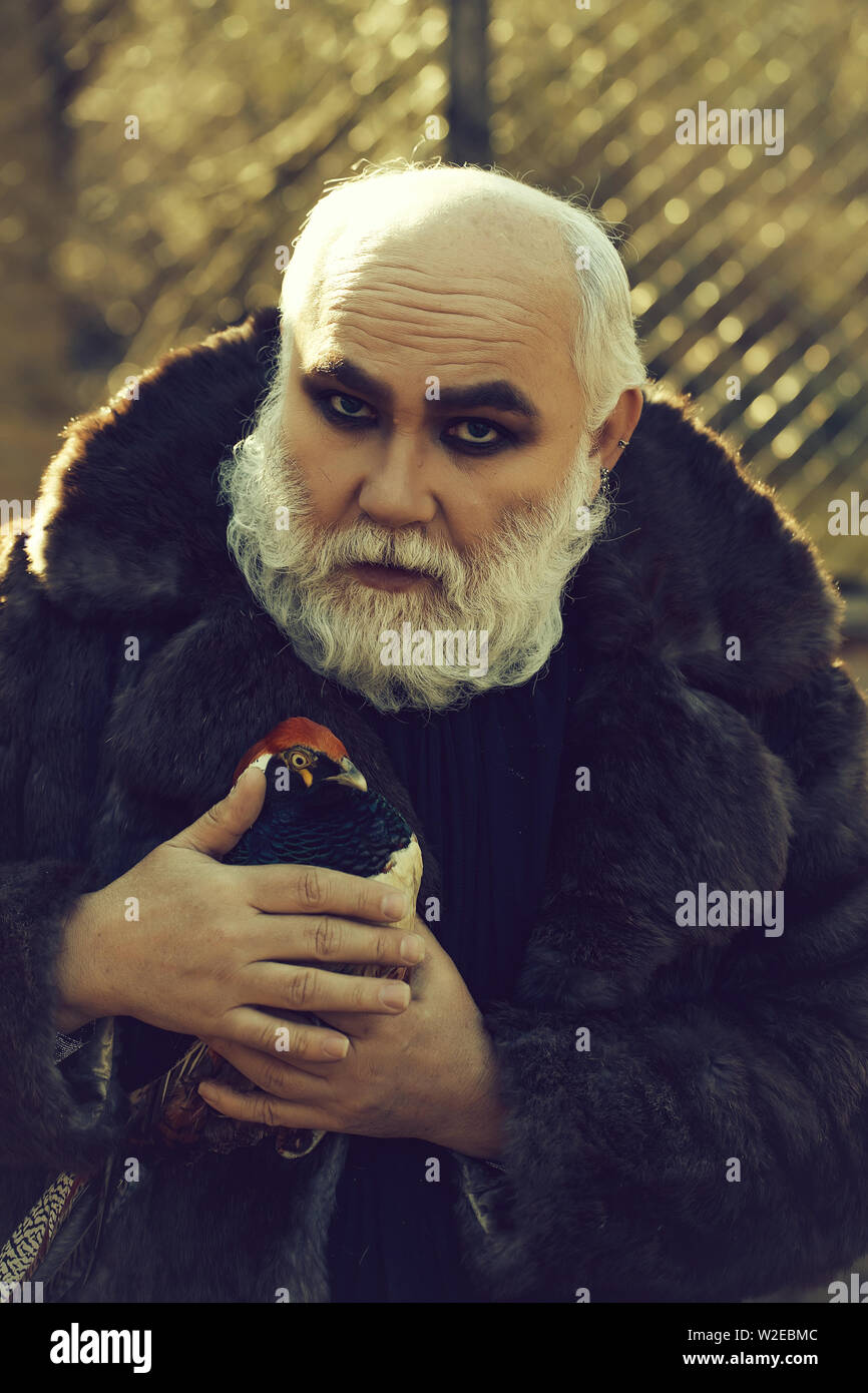old bearded man with long white beard on serious face with makeup in ...