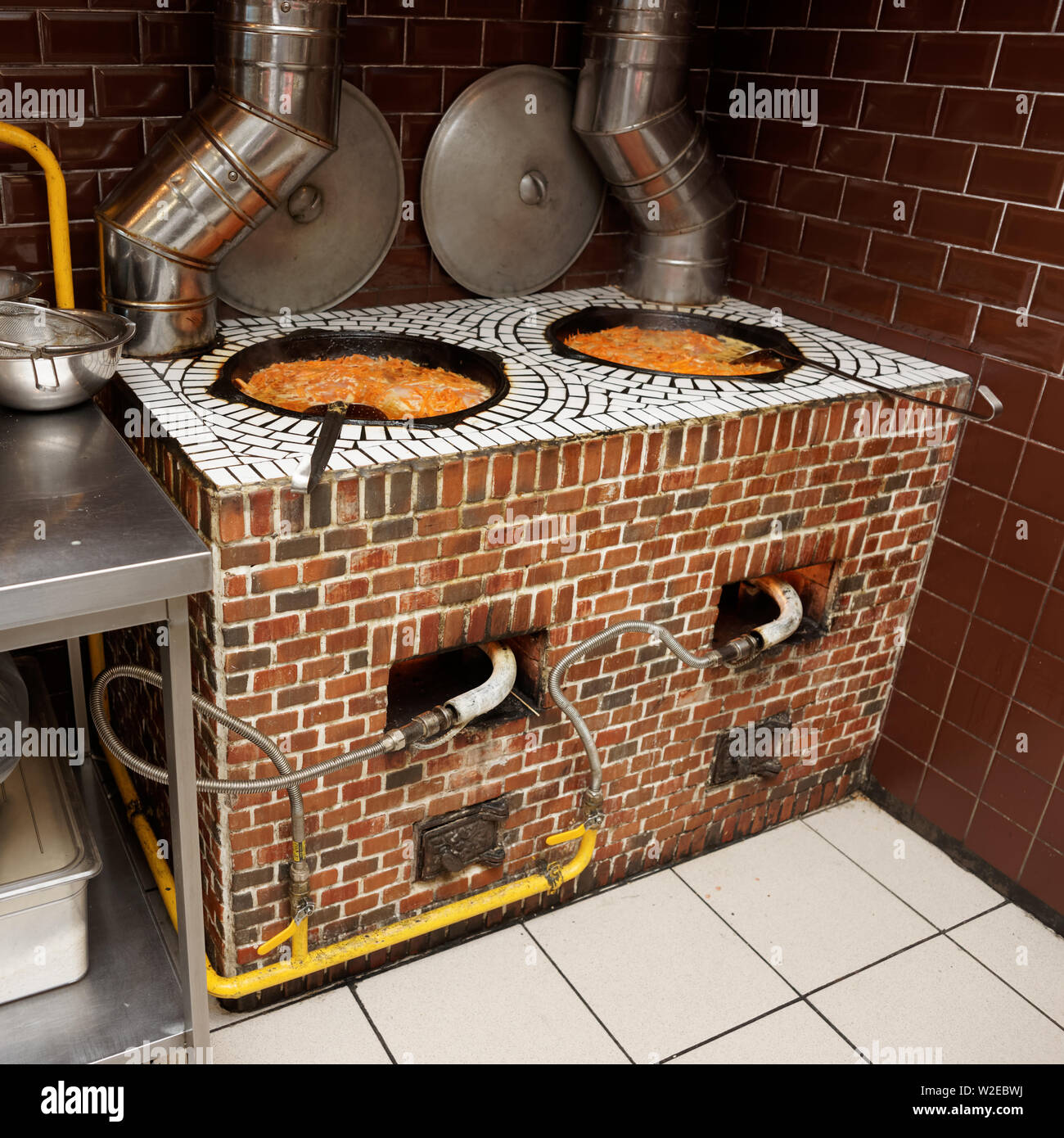 Gas stove in Middle Eastern cuisine restaurant, cooking carrot for ...