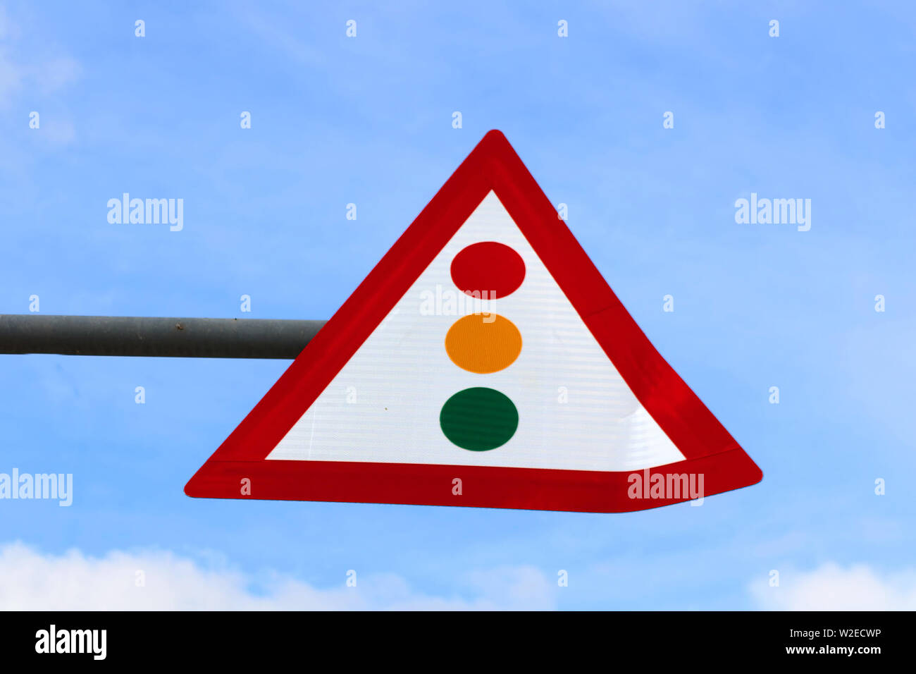 Sign "Attention traffic light" over blue sky Stock Photo - Alamy