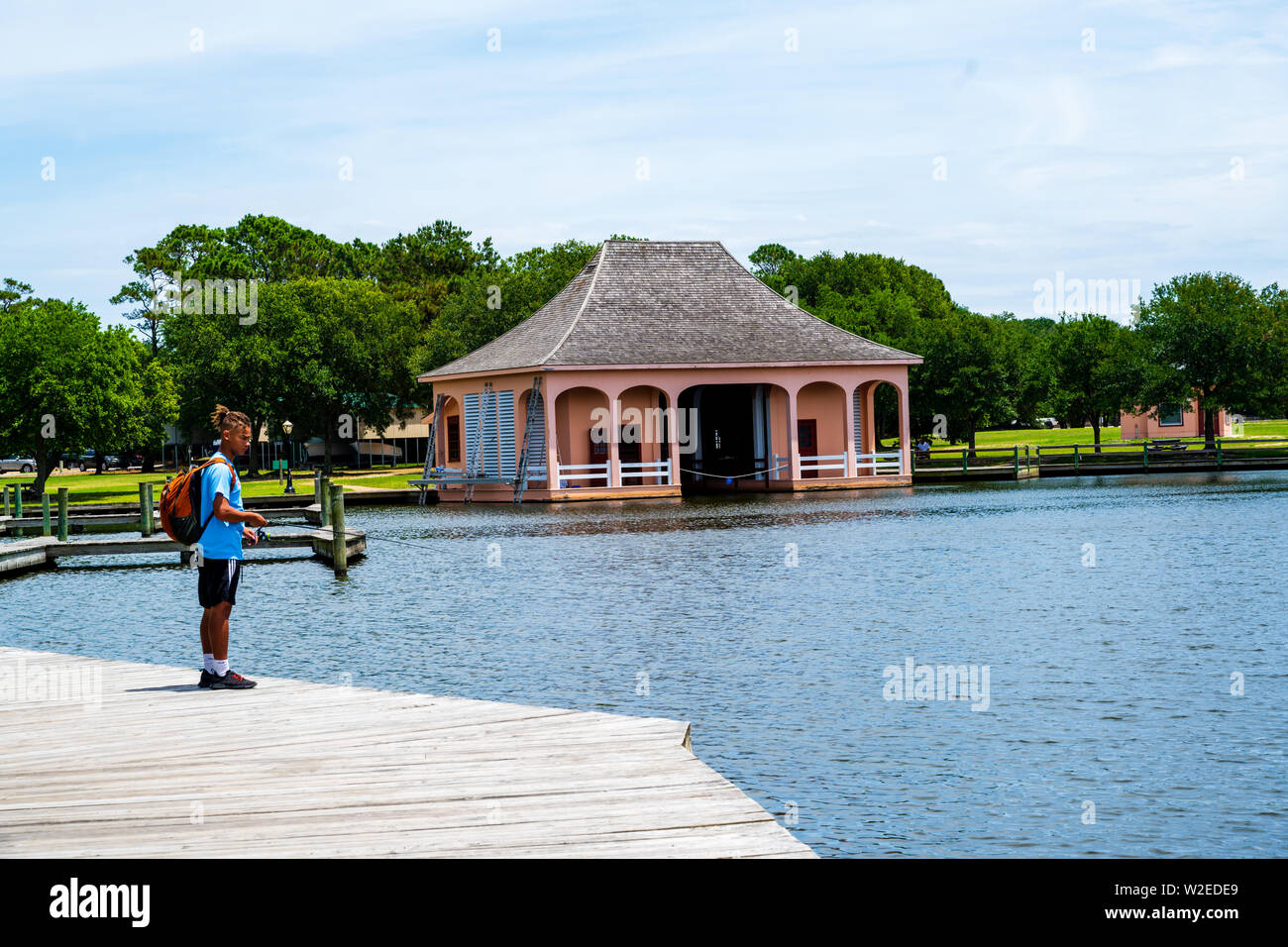 Corolla Park, North Carolina, USA -- June 10, 2019. A man fishes off ...