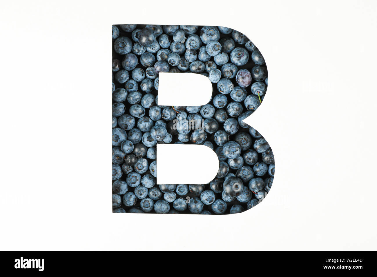 Letter B against blueberries backdrop isolated on white background ...