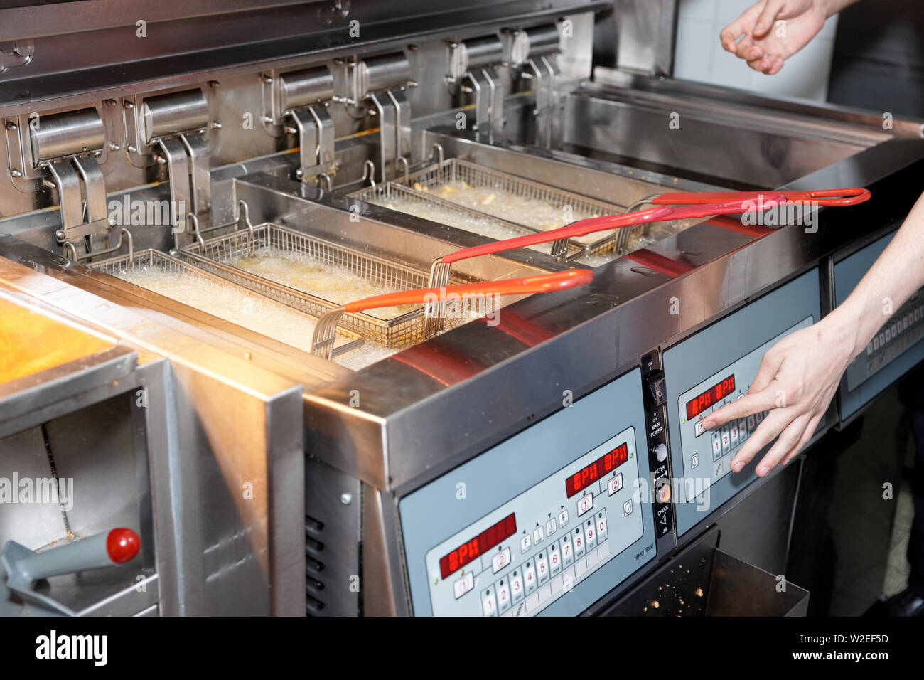 Deep fryer with boiling oil on restaurant kitchen Stock Photo - Alamy