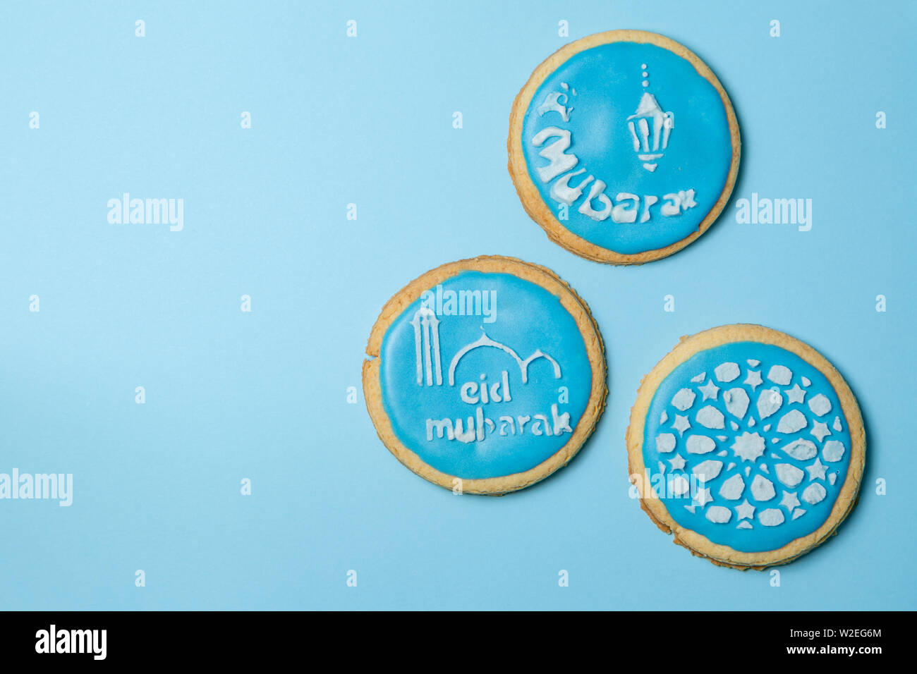 Eid Al-Adha Mubarak holiday concept - blue cookies with stenciled ...