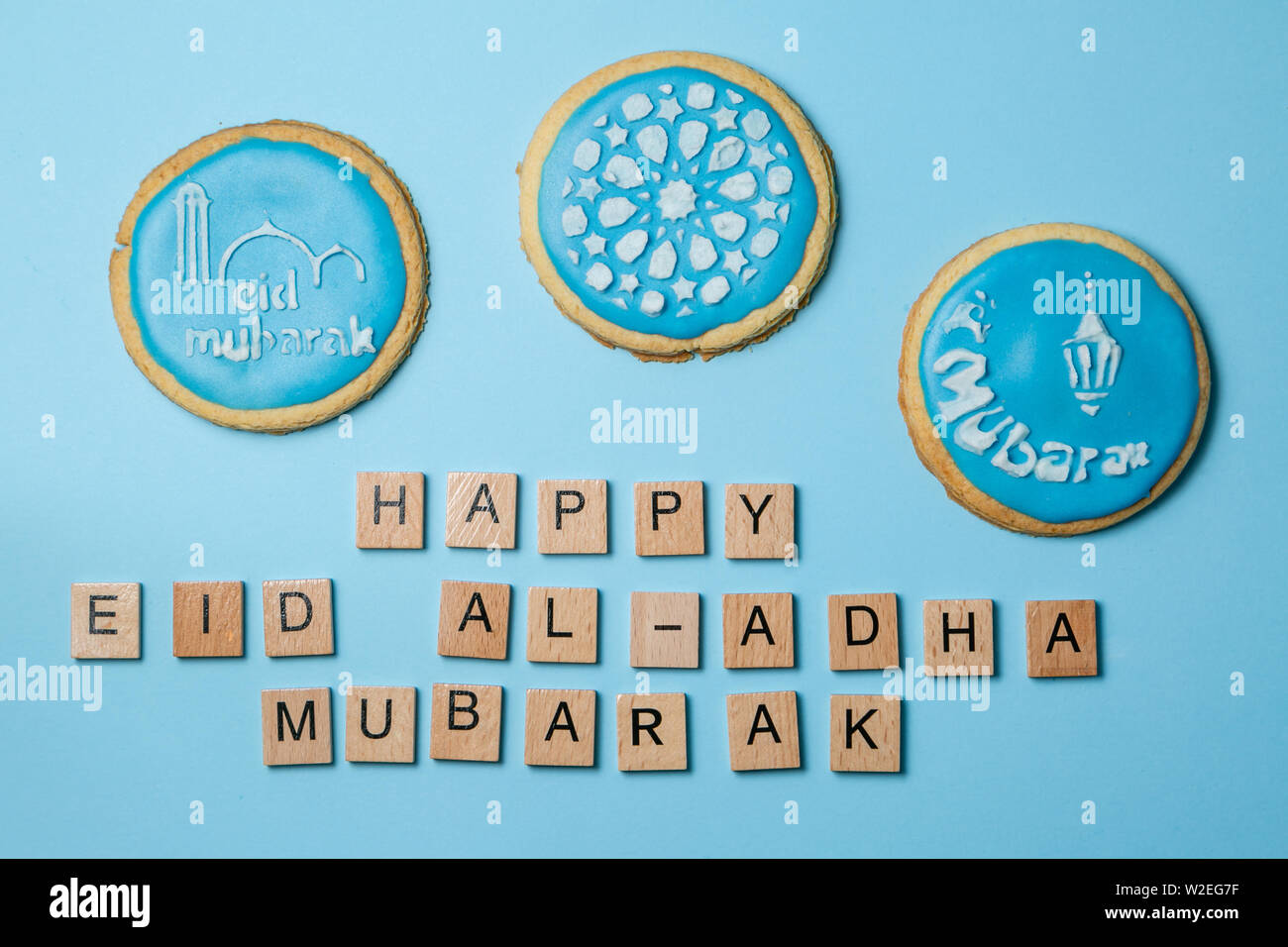 Eid Al-Adha Mubarak holiday concept - blue cookies with stenciled ...