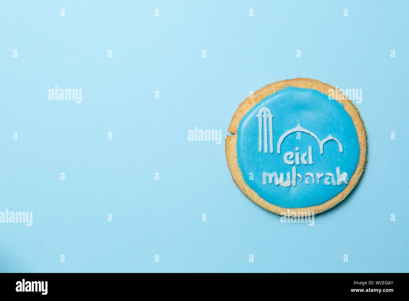 Eid Al-Adha Mubarak holiday concept - blue cookies with stenciled ...