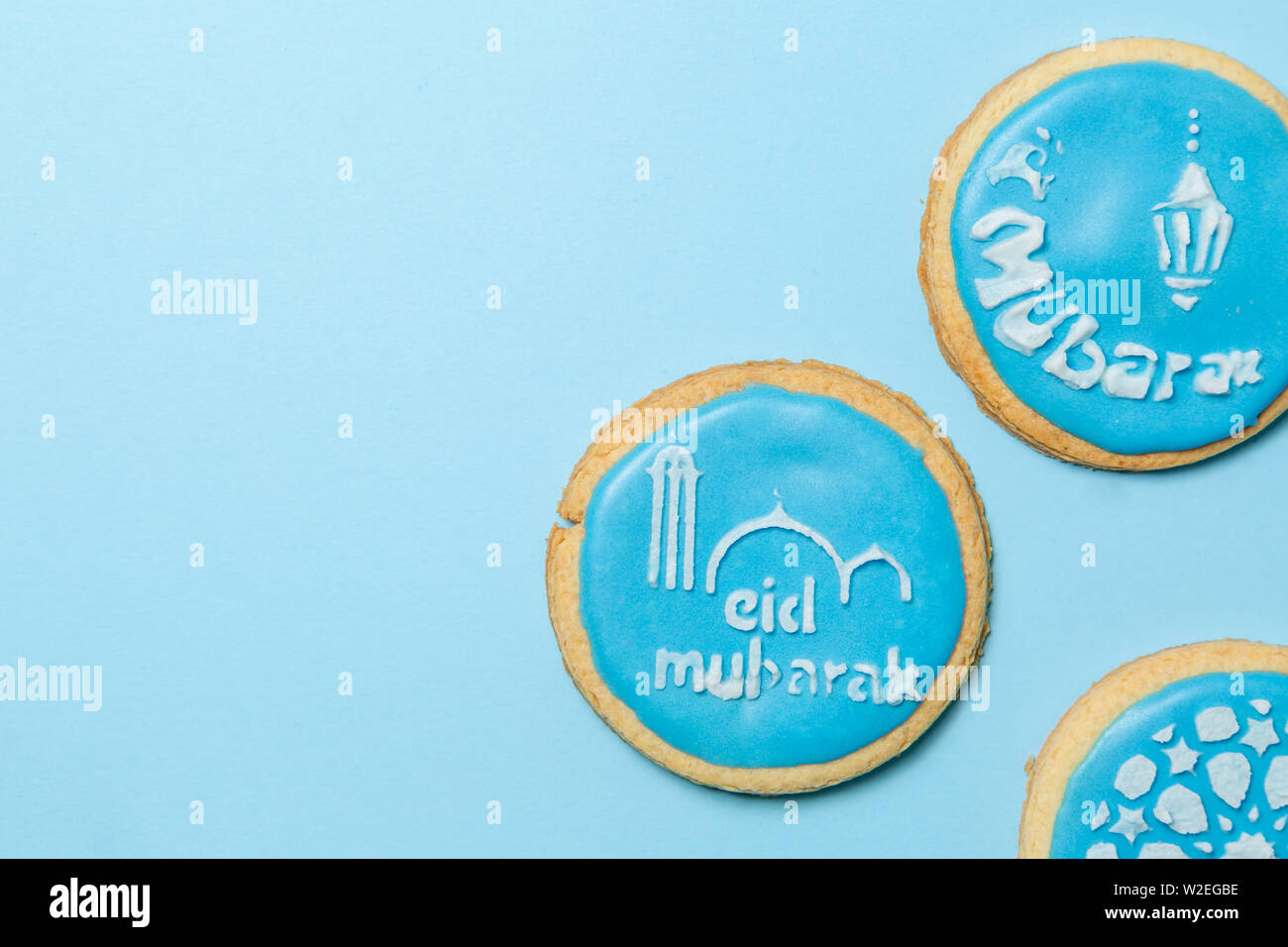 Eid Al-Adha Mubarak holiday concept - blue cookies with stenciled ...