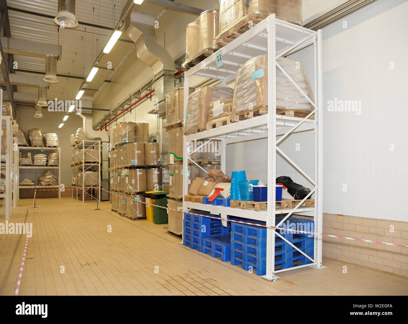 Large food warehouse with steel shelves, copy space Stock Photo - Alamy