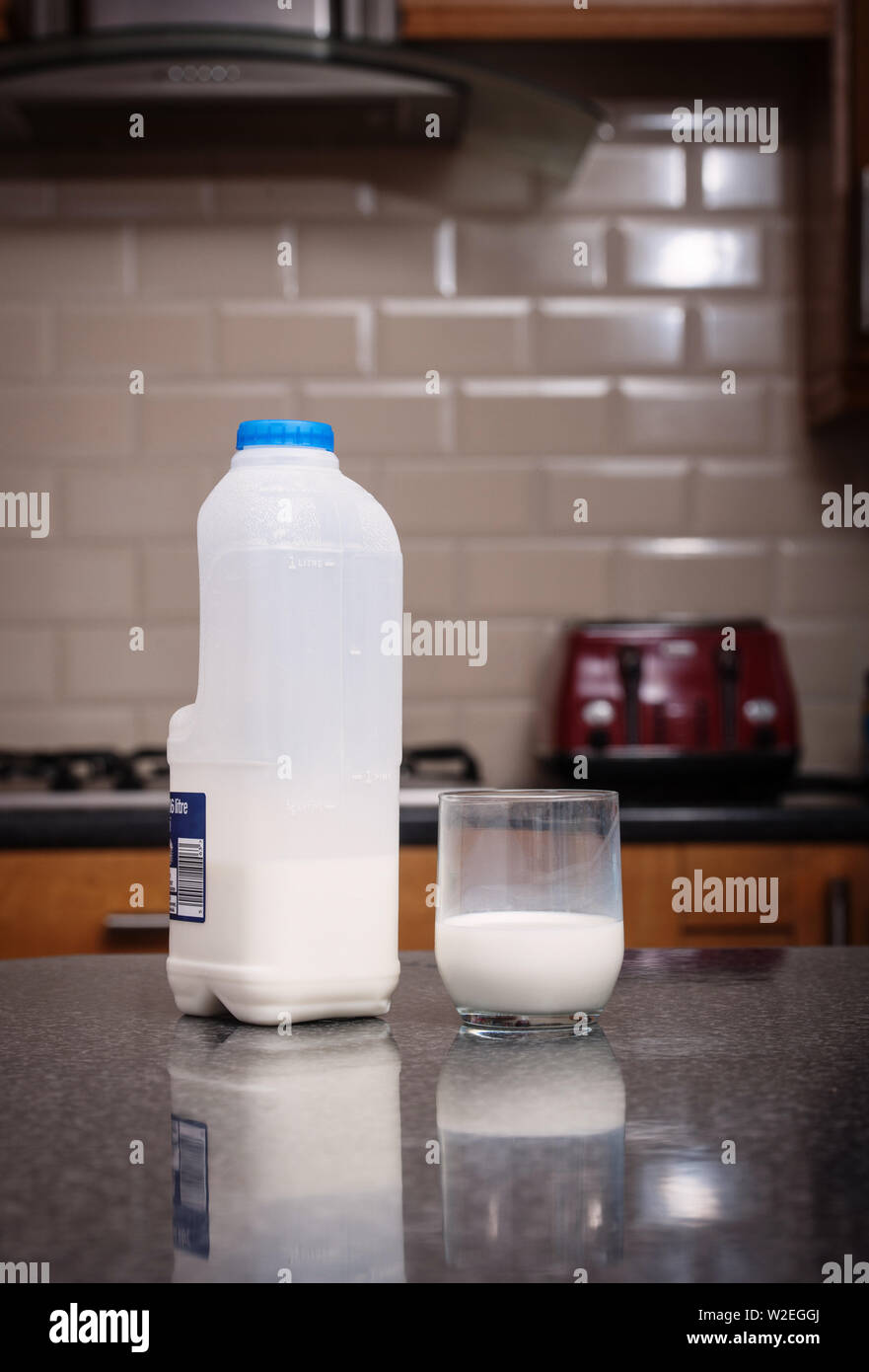 Carton & glass of milk on counter in kitchen Stock Photo - Alamy