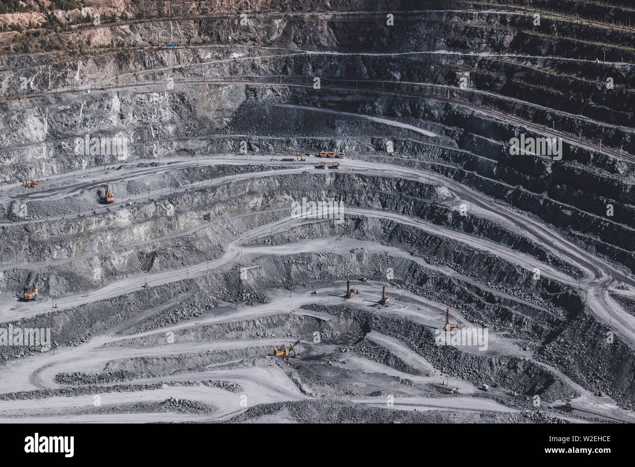 Aerial view industrial of opencast mining quarry with lots of machinery ...
