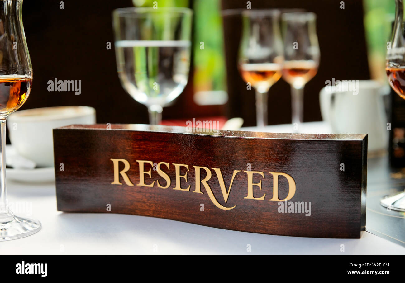 Wooden reserved plate on an arranged restaurant table Stock Photo - Alamy