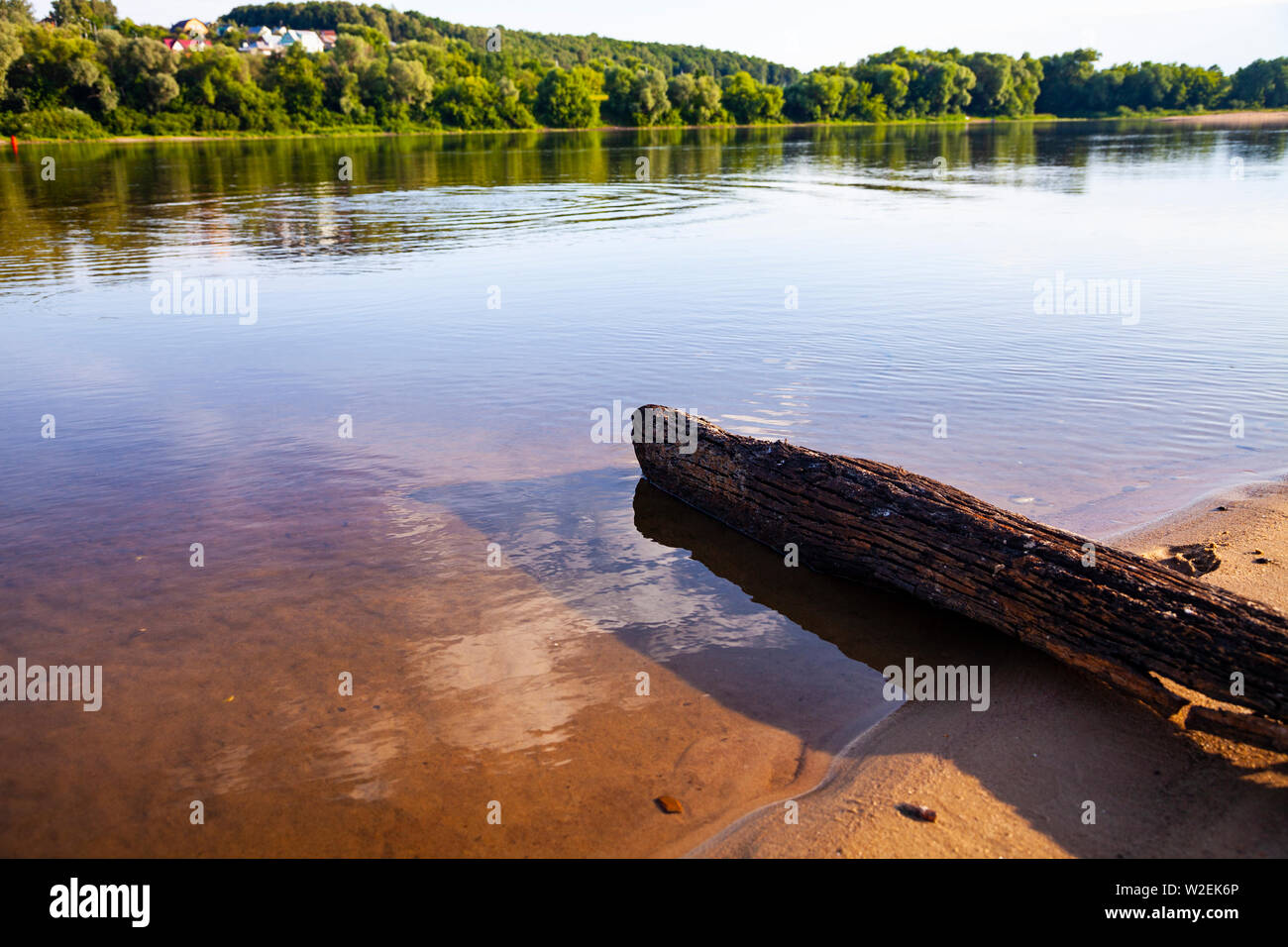 Beautiful landscape with a calm river. Fallen tree in the river Stock ...