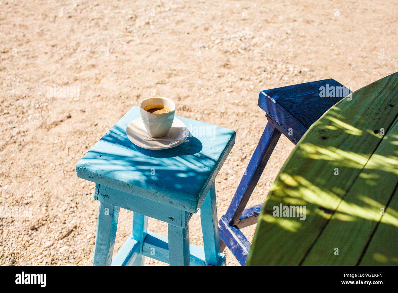 A cup of coffee on a chair on the beach in a cafe Stock Photo - Alamy