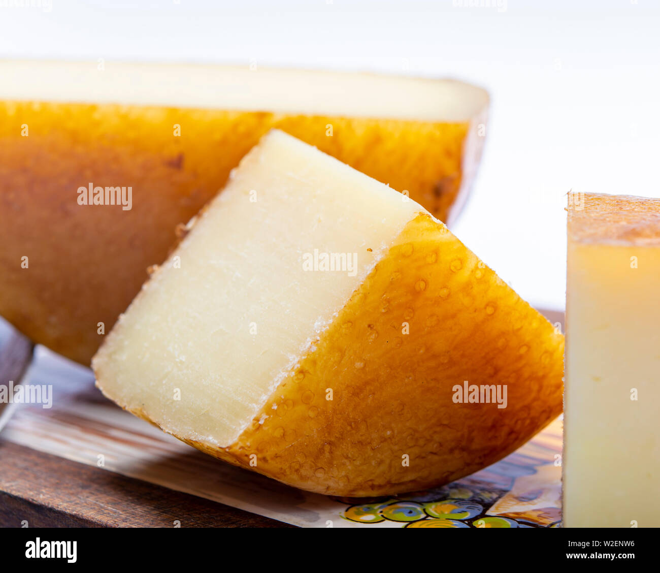 Hard Italian pecorino sheep cheese on wooden board close up isolated ...