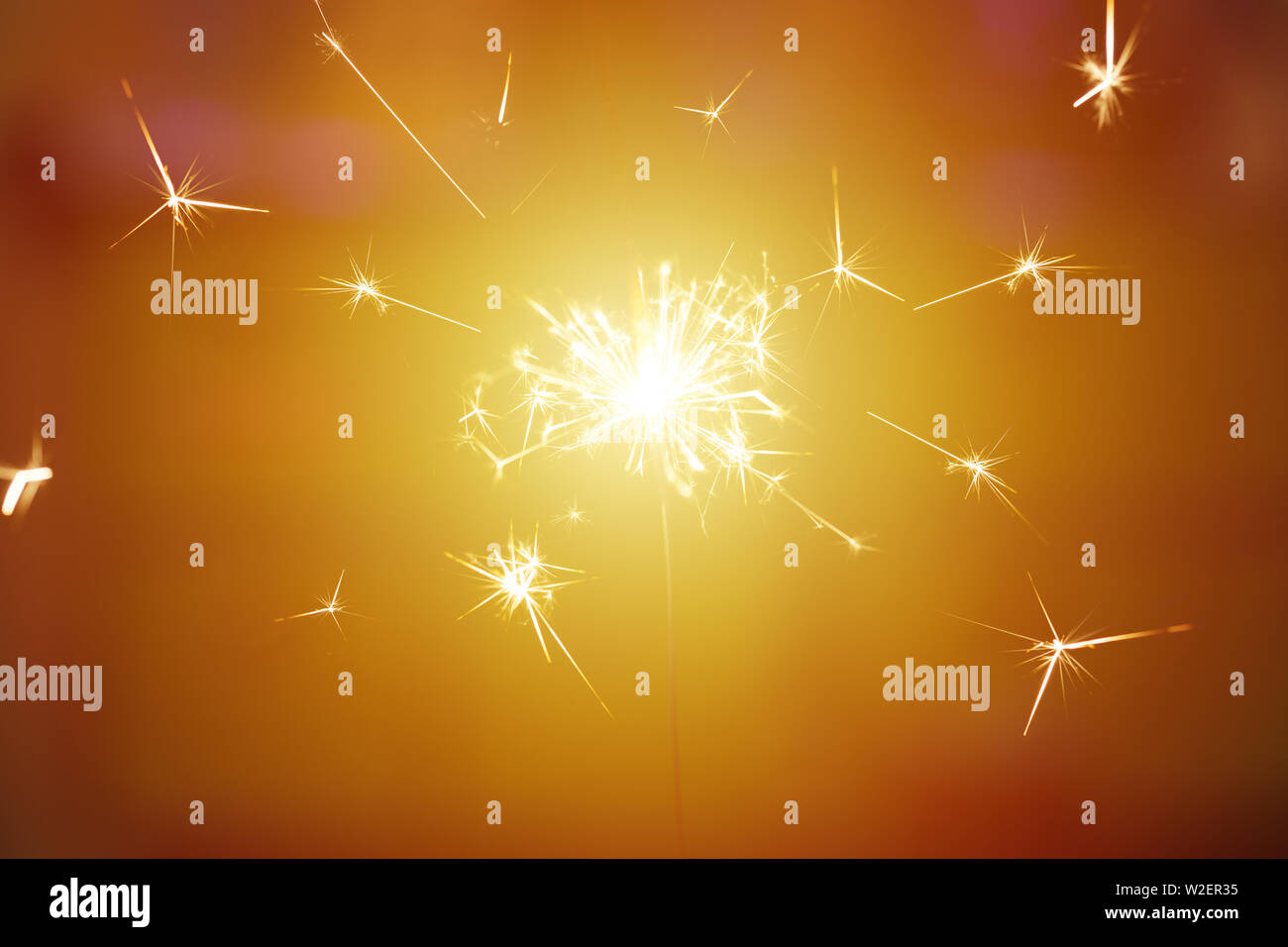 Sparks from hand cold fireworks color background Stock Photo - Alamy