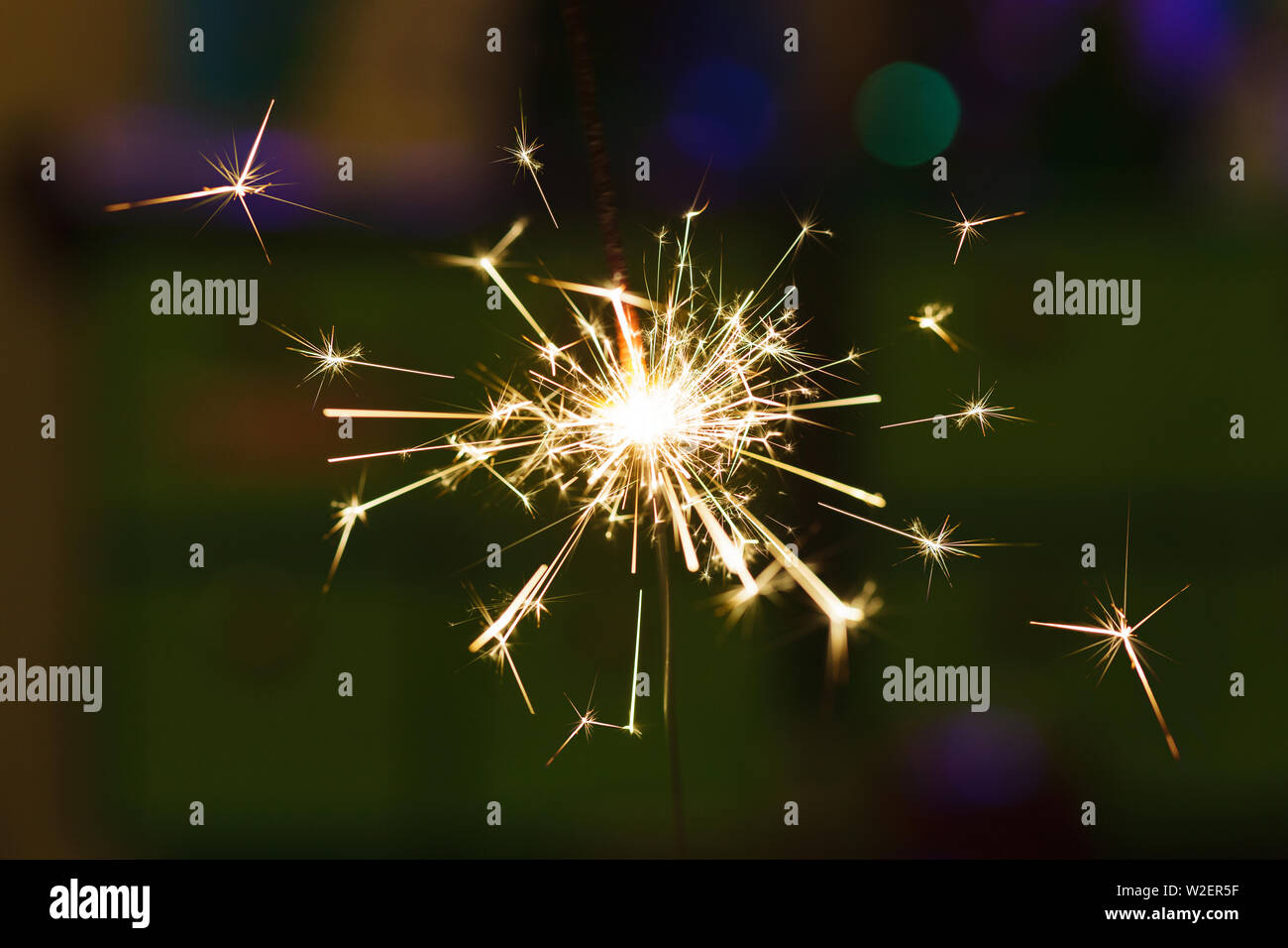 Sparks from hand cold fireworks color background Stock Photo - Alamy