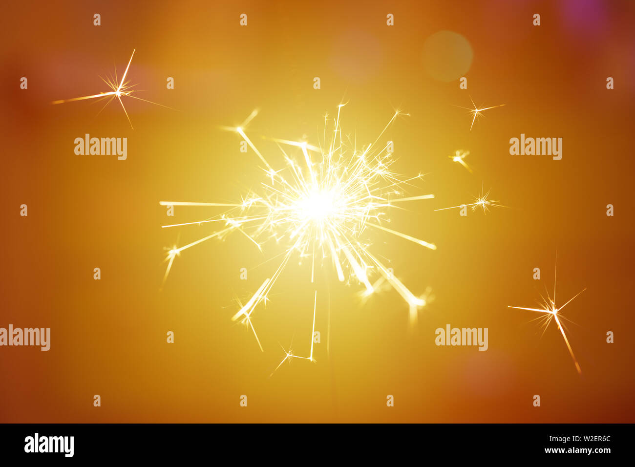 Sparks from hand cold fireworks color background Stock Photo - Alamy