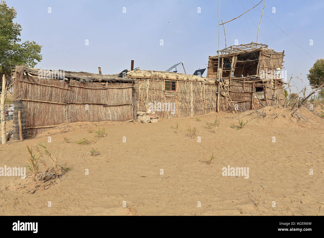 Exterior perimeter wall-Uyghur reeds and mud hut. Taklamakan Desert ...