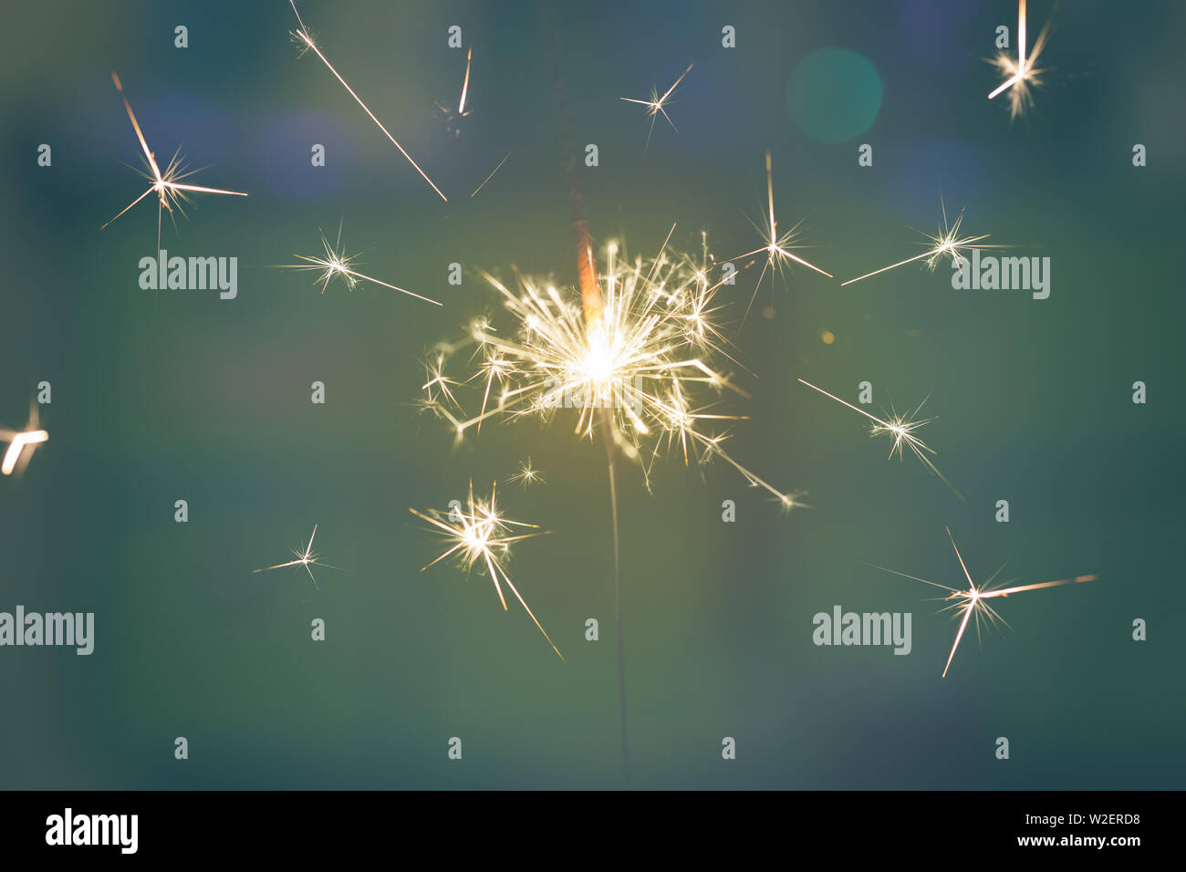 Sparks from hand cold fireworks color background Stock Photo - Alamy