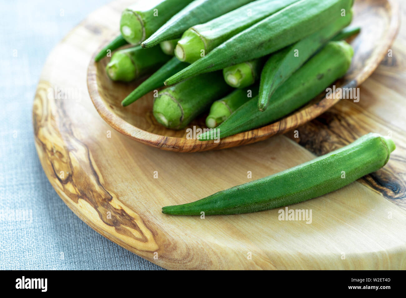 Green Okra on wooden surface Stock Photo - Alamy