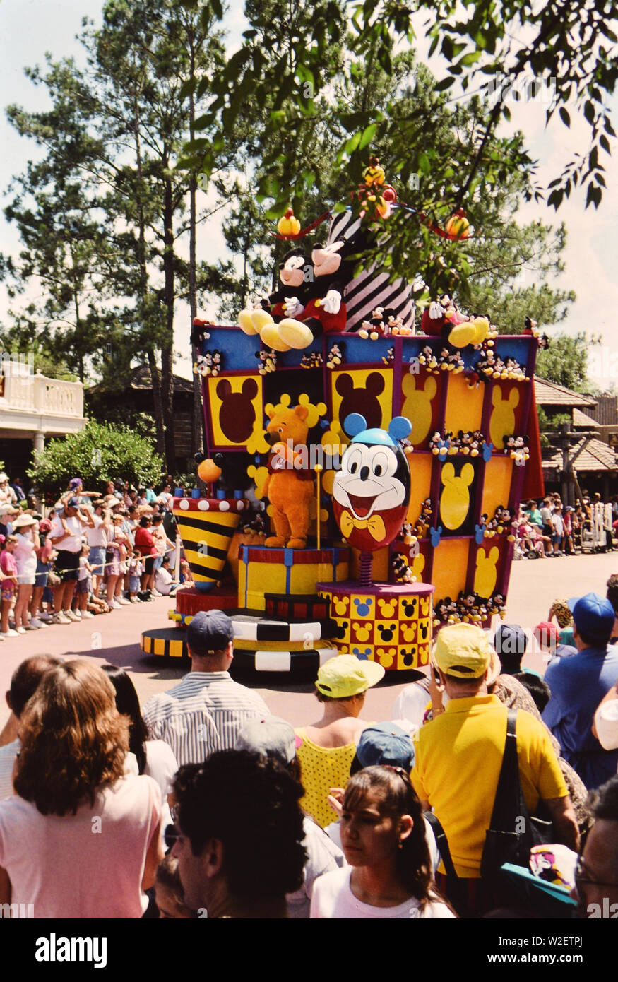 Families and children watching a float in a parade featured at a Walt ...