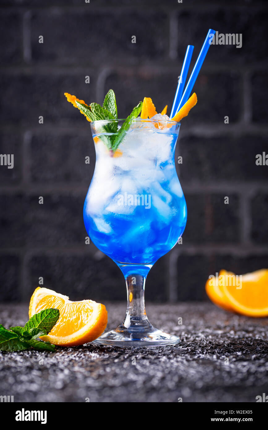 Blue cocktail drink with ice and orange Stock Photo - Alamy