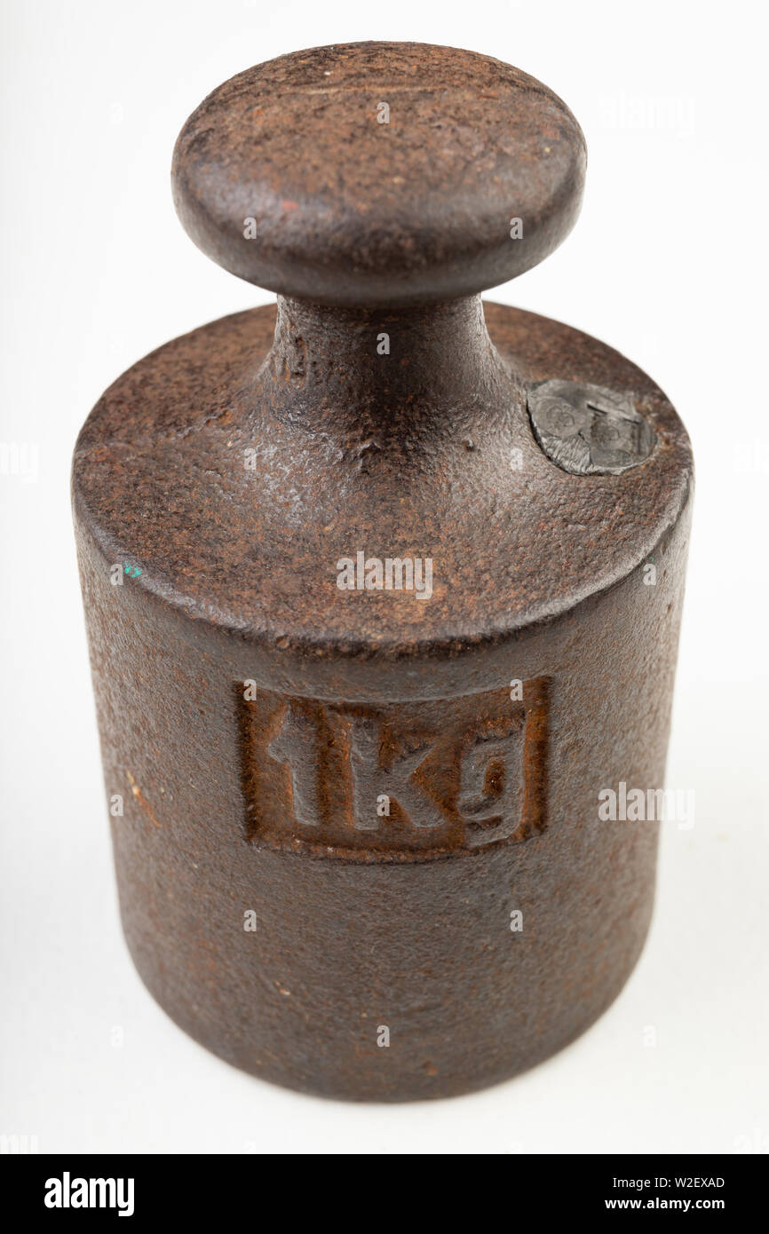 Old weights for weighing on a white table. Steel weights worth 1 ...