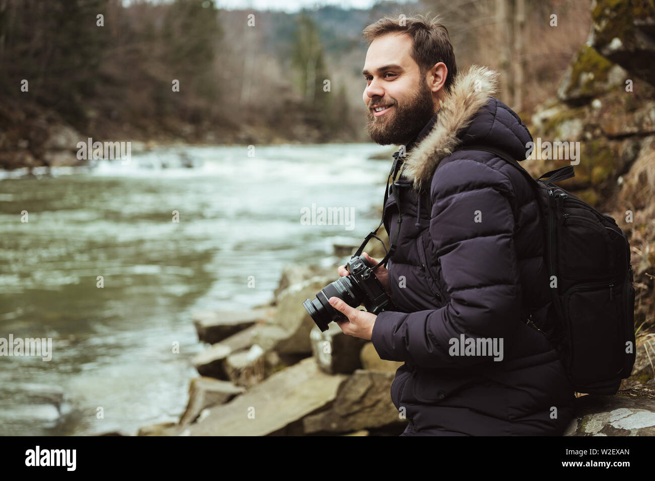 Man traveler photographer with camera photographing the river Stock ...