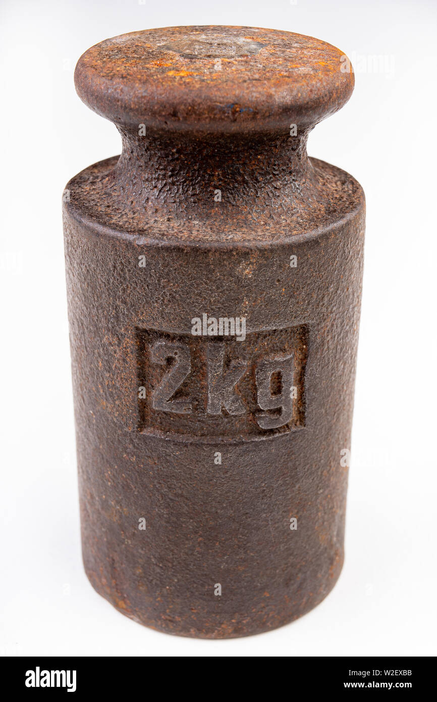 Old weights for weighing on a white table. Steel weights worth 2 ...