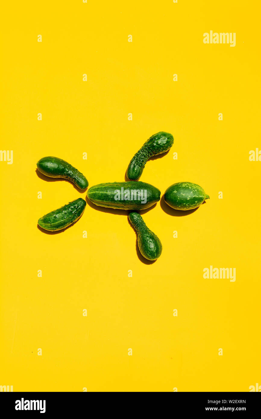 Cucumber man on a yellow background. Figure of man made from cucumbers ...
