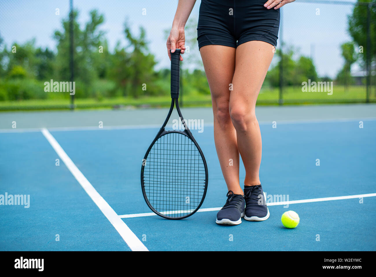 Beautiful female legs with tennis racket on tennis blue court Stock ...