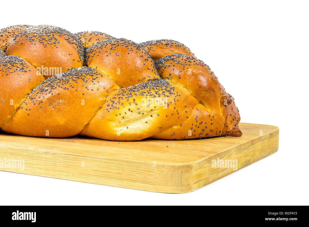 Closeup of fresh whole challah bread on chopping board isolated on ...