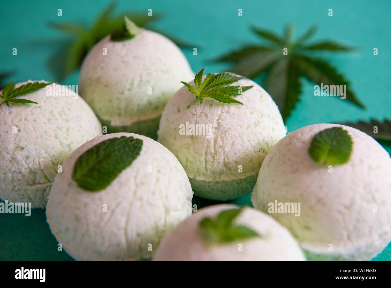 Round green cannabis bath bombs with marijuana & mint leaves on green ...