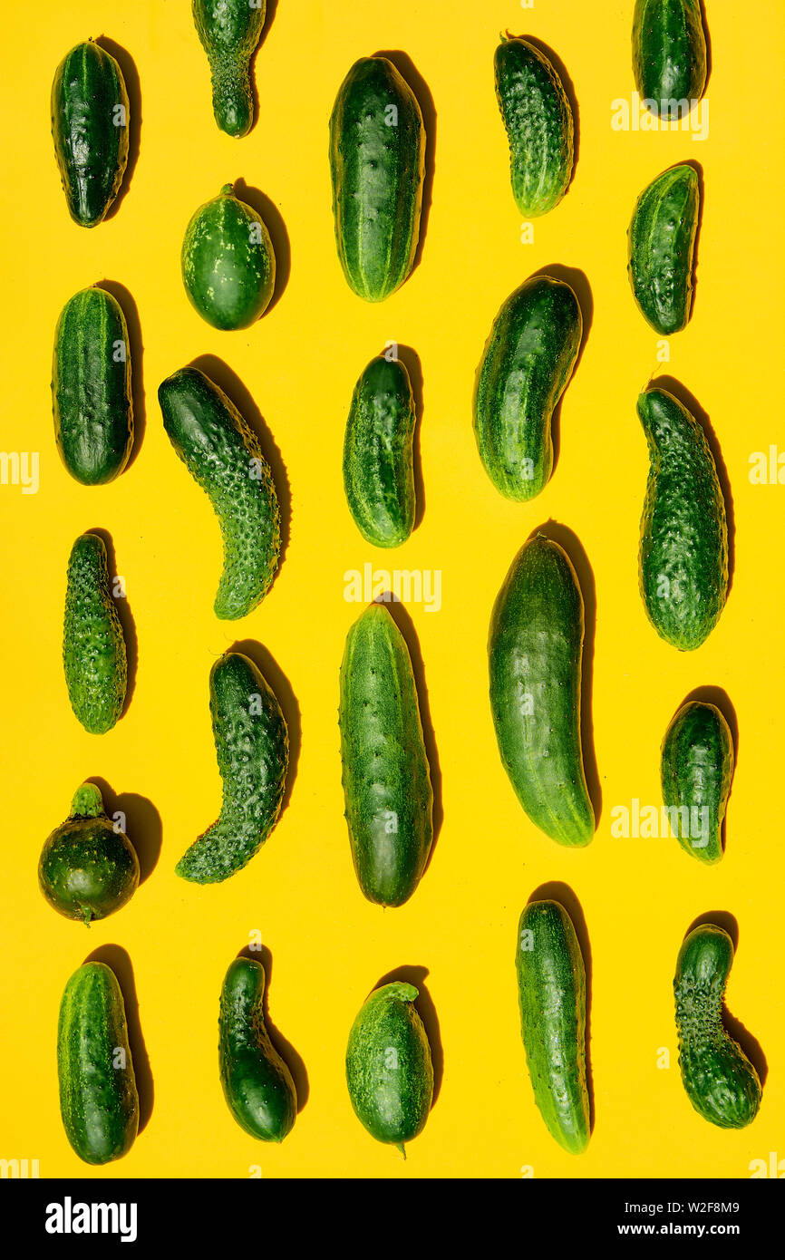 Different sizes forms cucumbers pattern on a light yellow background ...