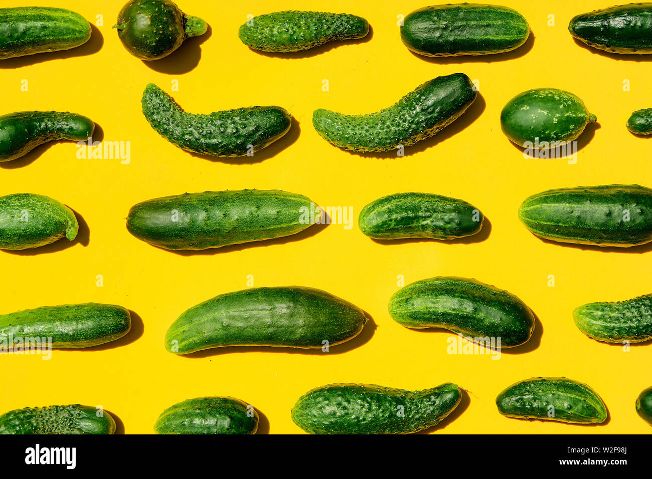 Different sizes forms cucumbers pattern on a light yellow background ...