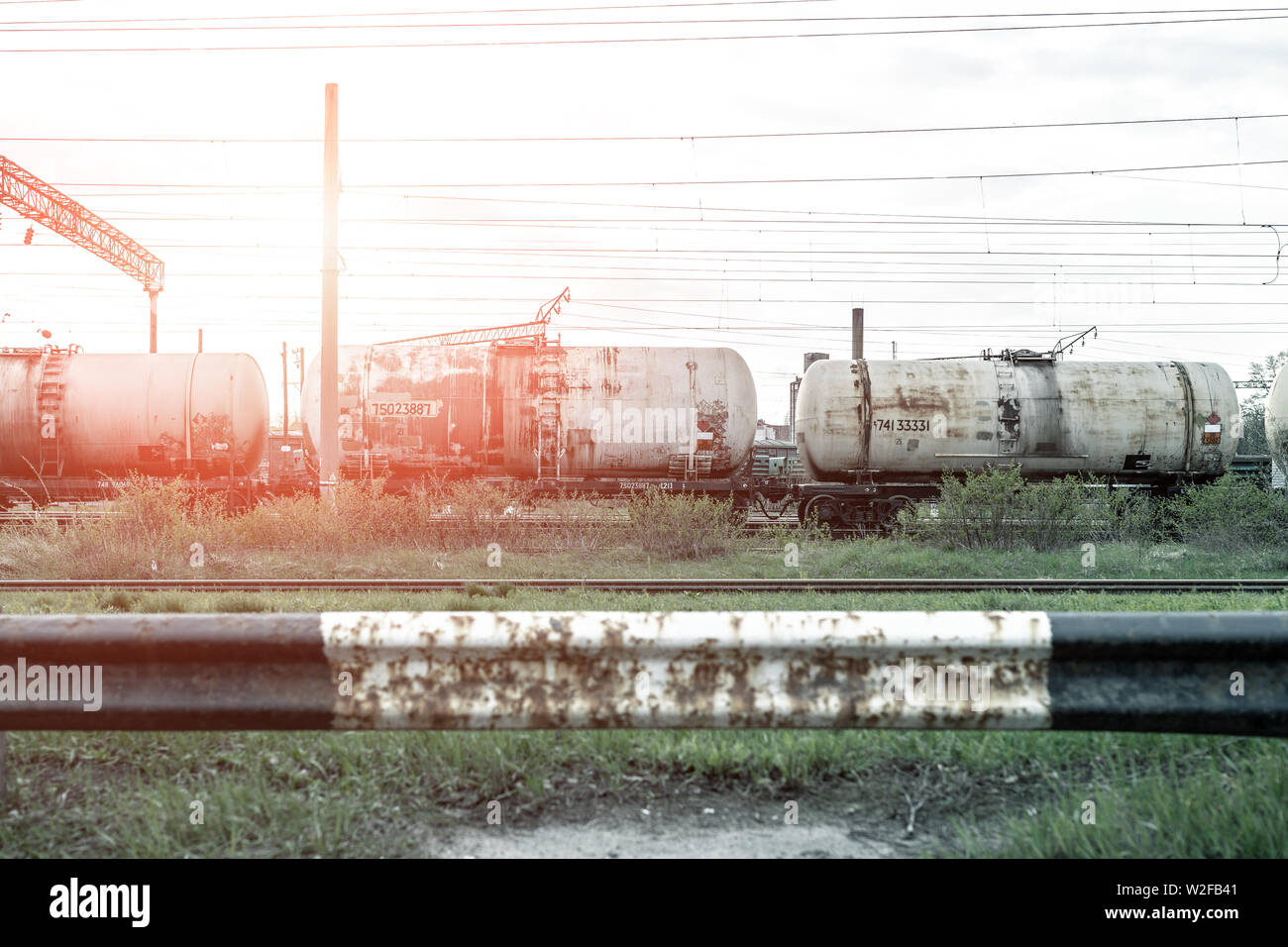 Old rusty tanker wagon at railway station. Freight industrial ...